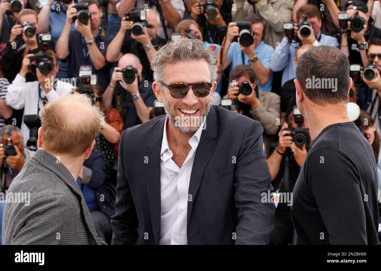 Actor Vincent Cassel, center, poses for photographers alongside actor ...