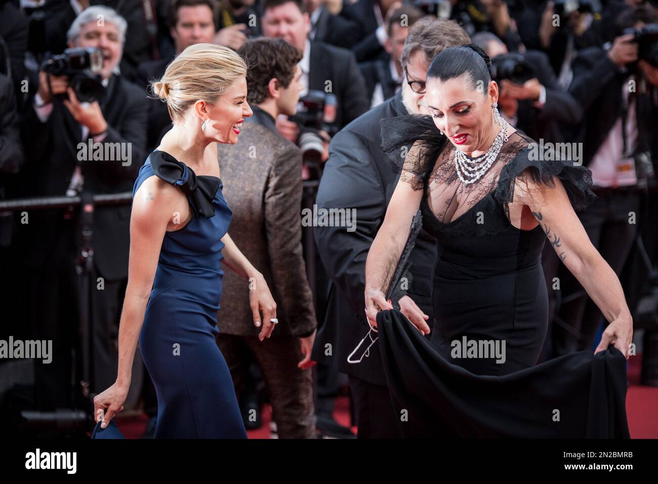 Sienna Miller and Rossy de Palma speak with each other upon arrival at ...