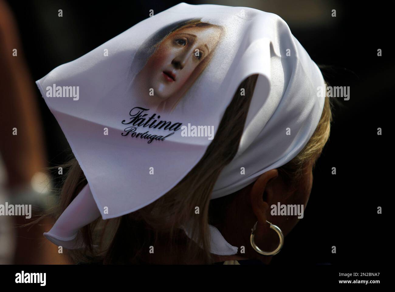 A worshipper wearing a kerchief with the image of the Our Lady of ...
