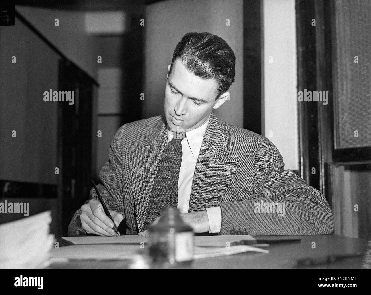 Jimmy Stewart shown signing documents as he is inducted into the U.S ...