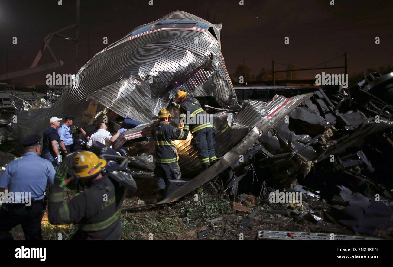 Emergency personnel work the scene of a train wreck, Tuesday, May 12 ...