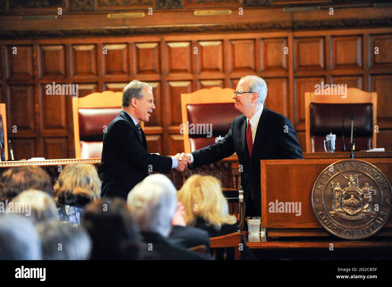 New York Attorney General Eric T. Schneiderman ,left, is greeted by New ...