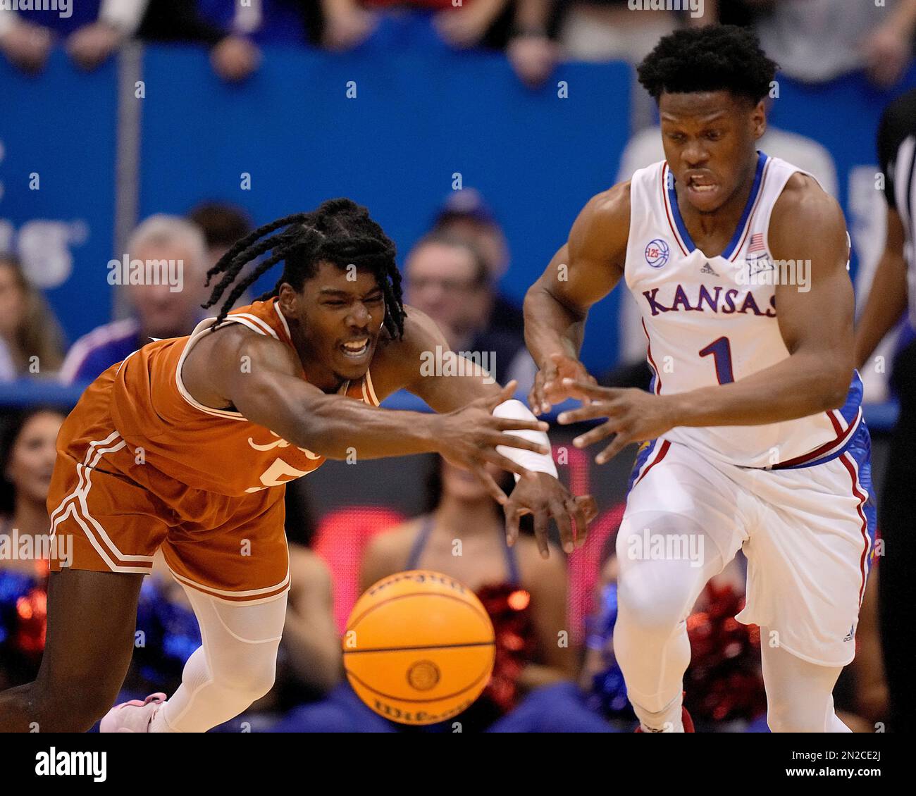Texas guard Marcus Carr, left, and Kansas guard Joseph Yesufu (1) chase ...