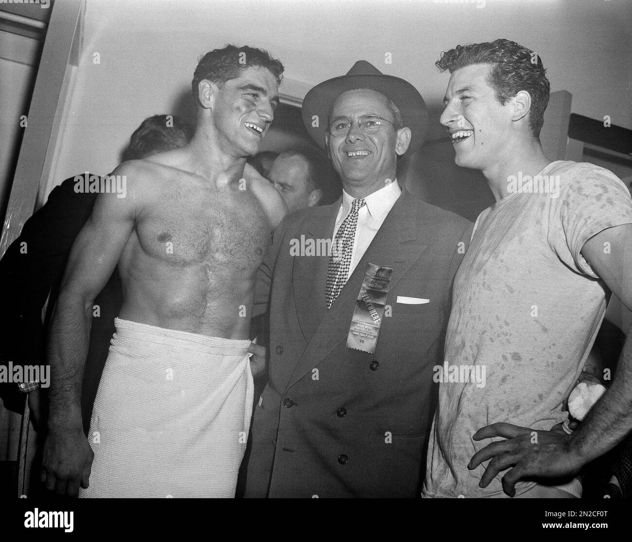 Coach Jess Hill of USC stands with halfback Rudy Bukich, right, who ...