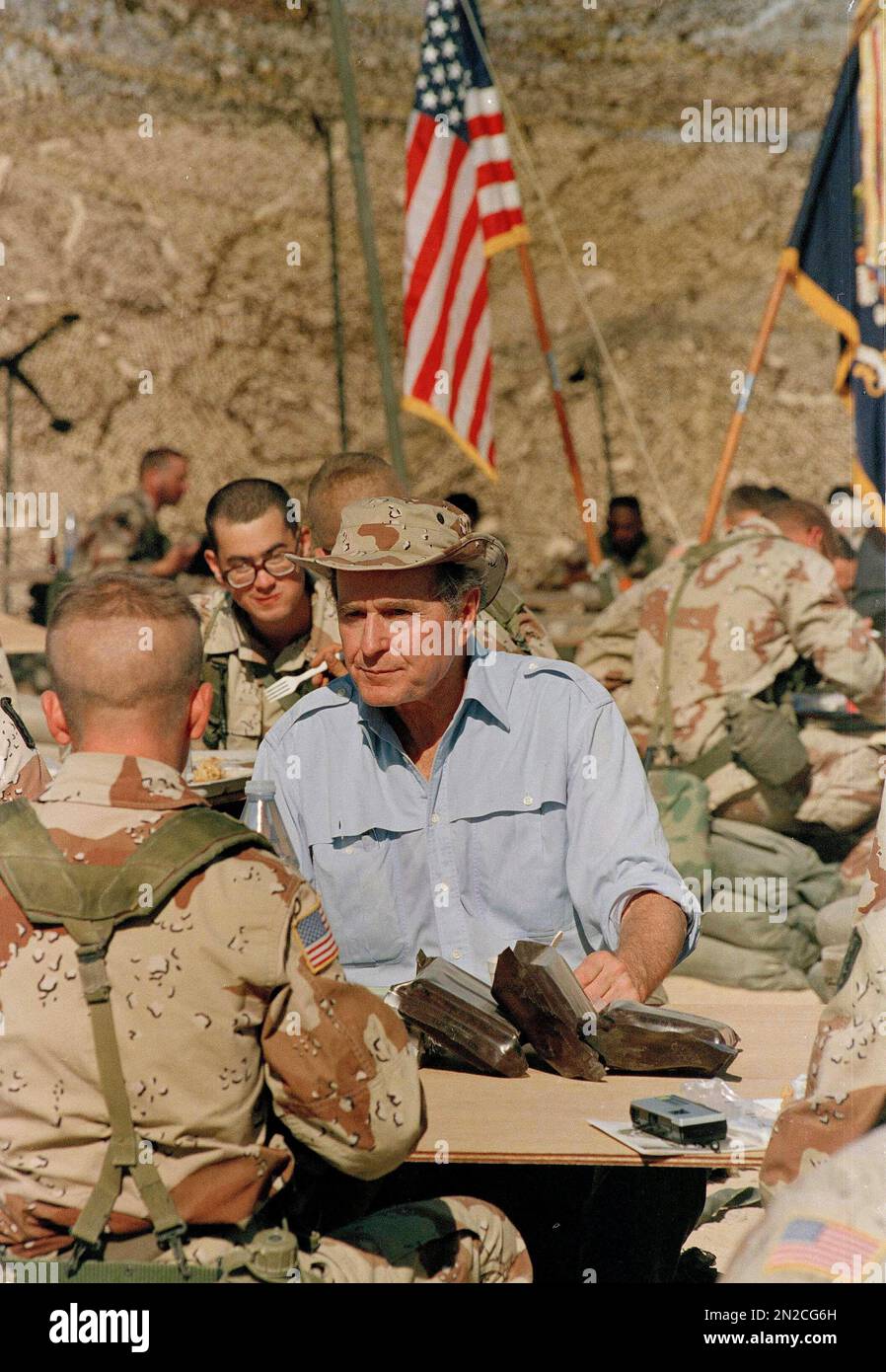 President George Bush shares a Thanksgiving dinner Thursday, Nov. 22 ...