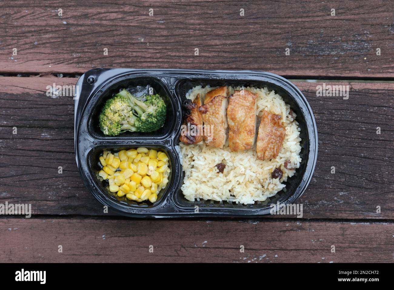 curry chicken and rice in a take away plastic packet on table Stock ...