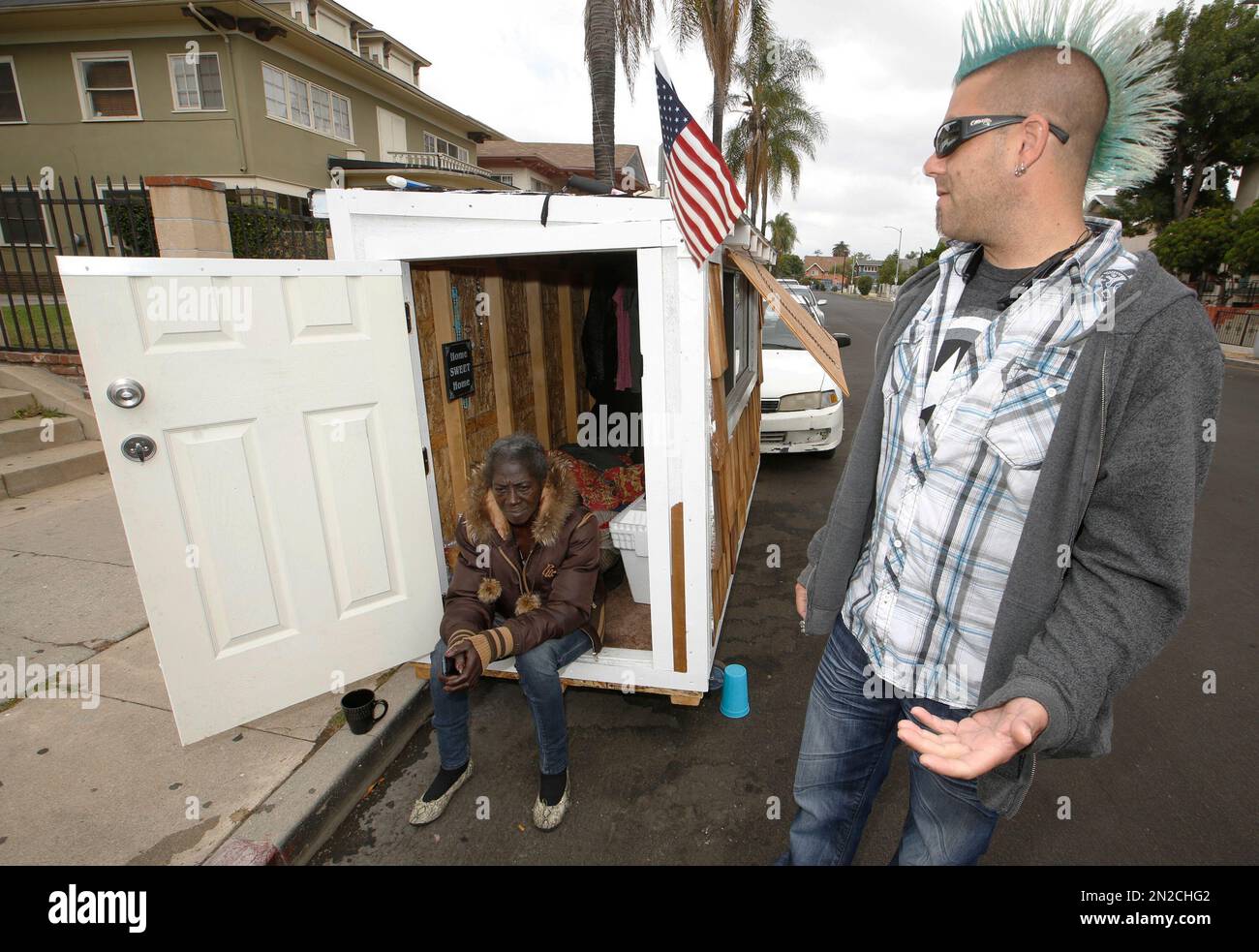 Los Angeles resident Elvis Summers, right, poses with his tiny house on ...