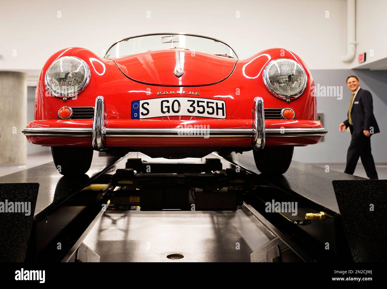 A 1956 Porsche Speedster sits in the restoration center as guests take ...