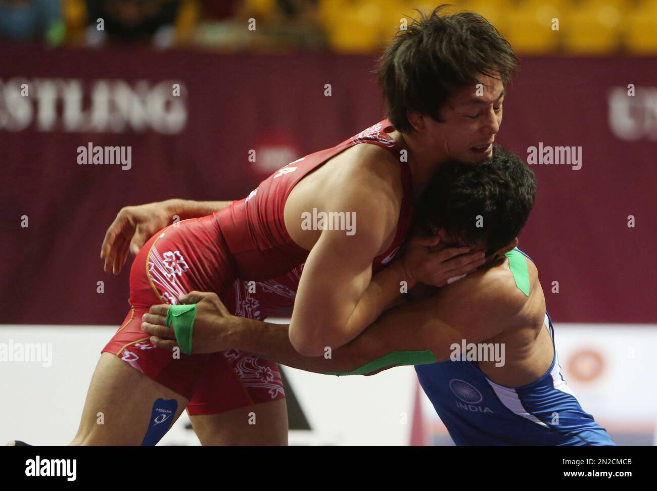 Japanese wrestler Takafumi Kojima , left, grapples with Indian wrestler ...