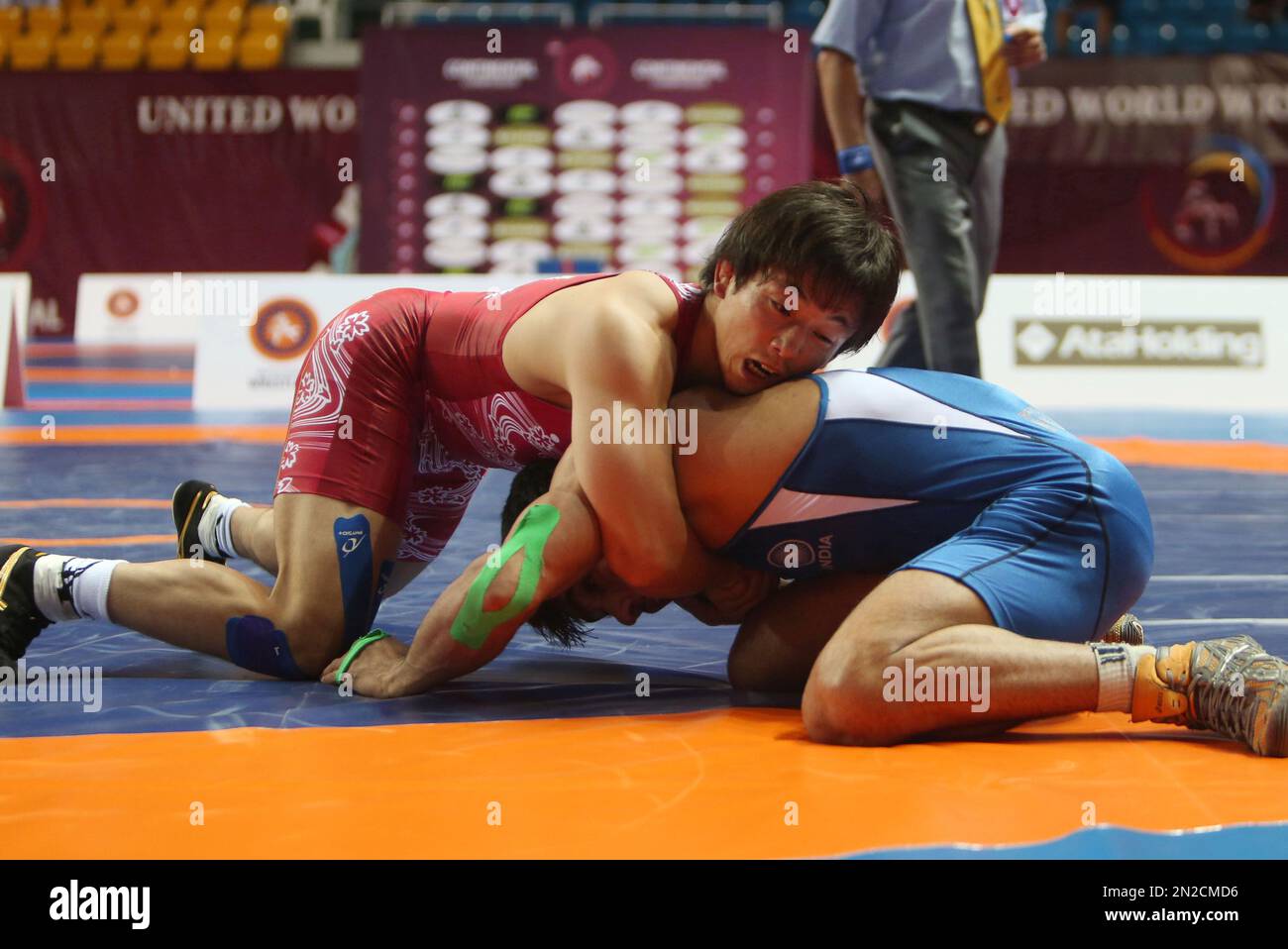 Japanese wrestler Takafumi Kojima , left, grapples with Indian wrestler ...
