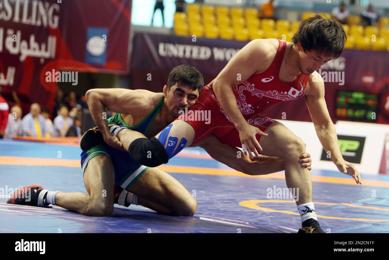 Japanese wrestler Takafumi Kojima, right, wrestles Uzbek wrestler ...