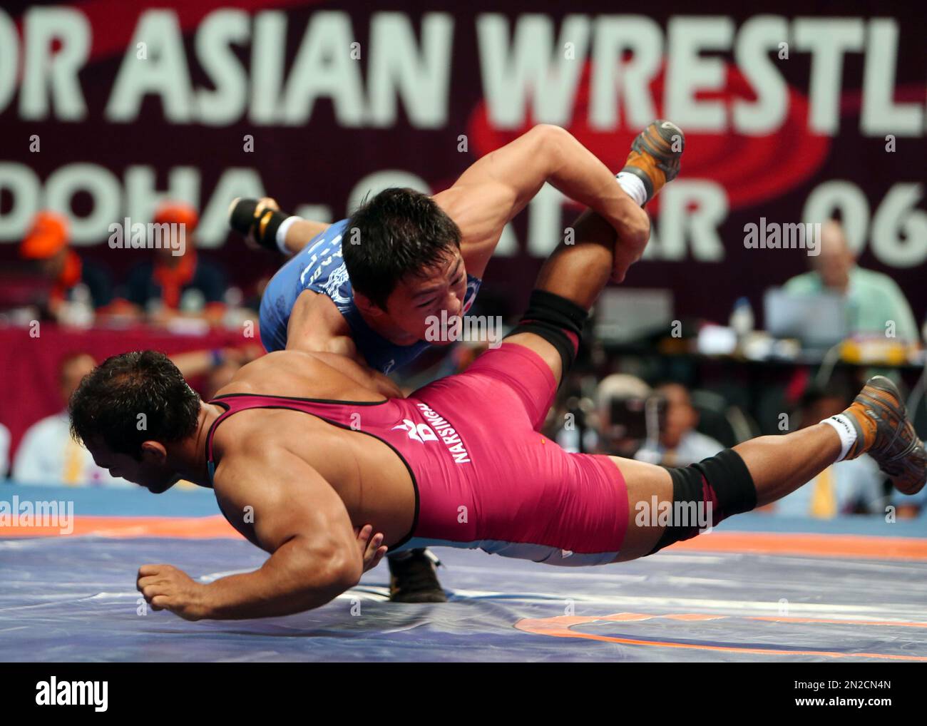 Japanese wrestler Daisuke Shimada, back, wrestles Indian wrestler ...