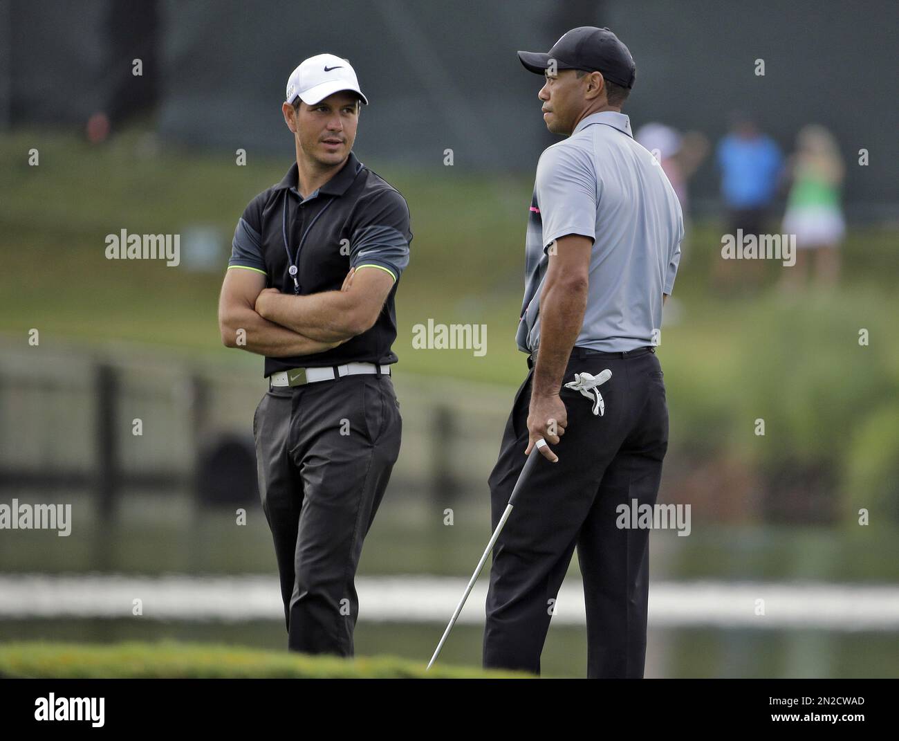 Tiger Woods, right, with swing coach Chris Como on the 17th green ...