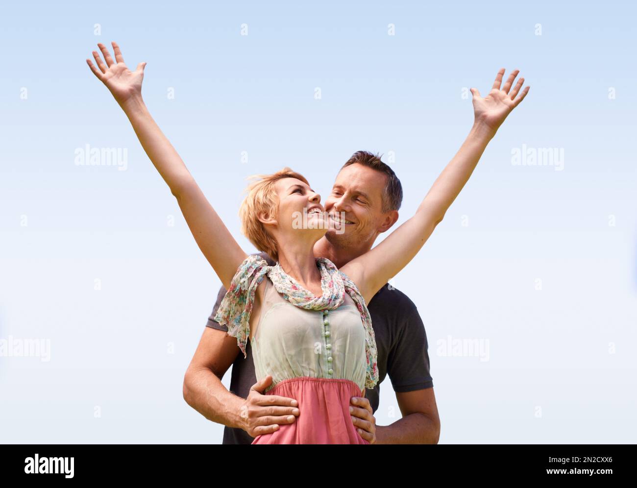 A healthy marriage keeps the spirit young. a mature woman standing with ...