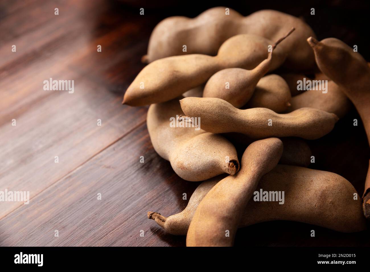 Tamarind fruit (Tamarindus indica) on wooden rustic table. Tropical ...