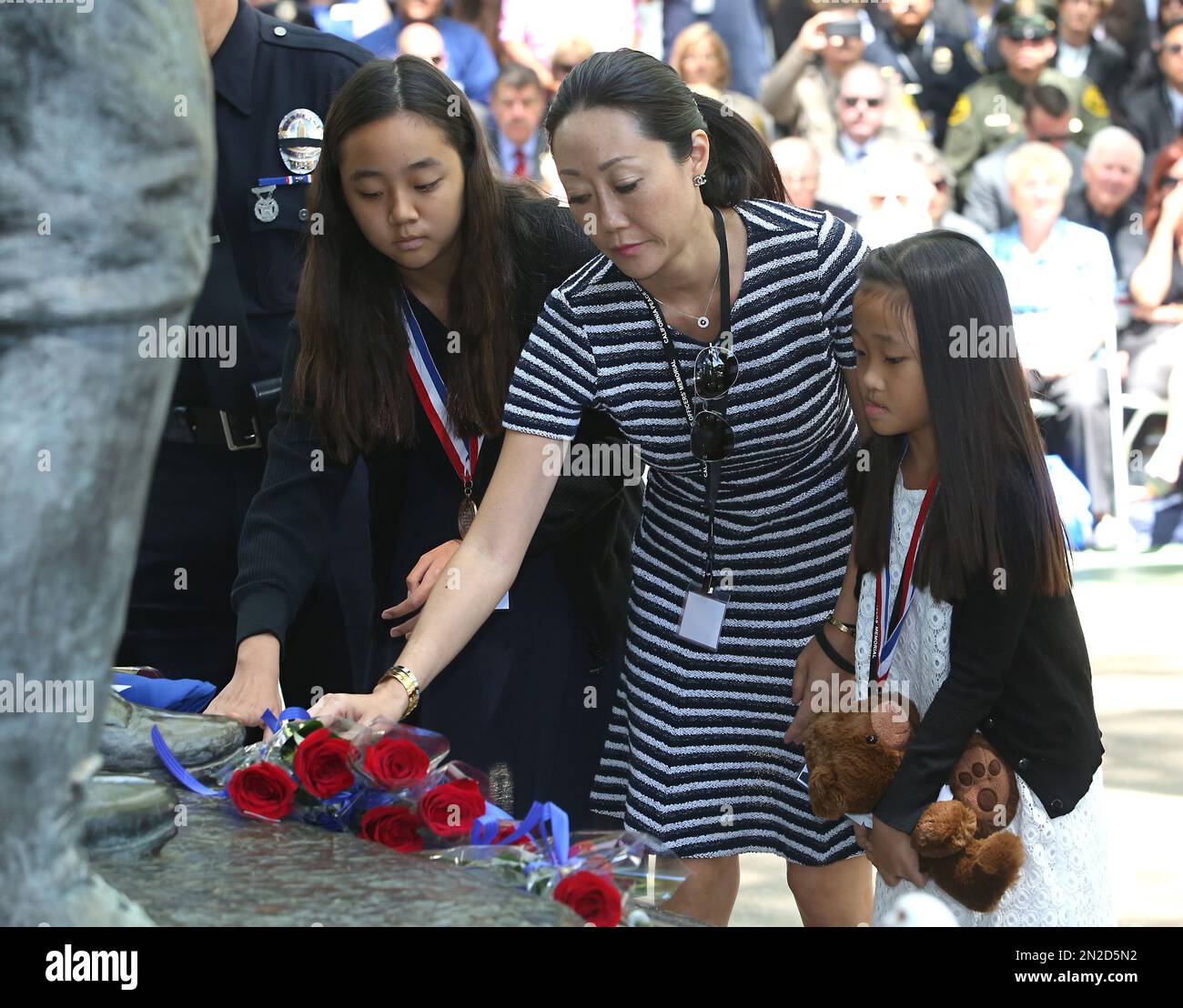 Catherine Lee, center, the wife of Los Angeles Police Officer Nicholas ...