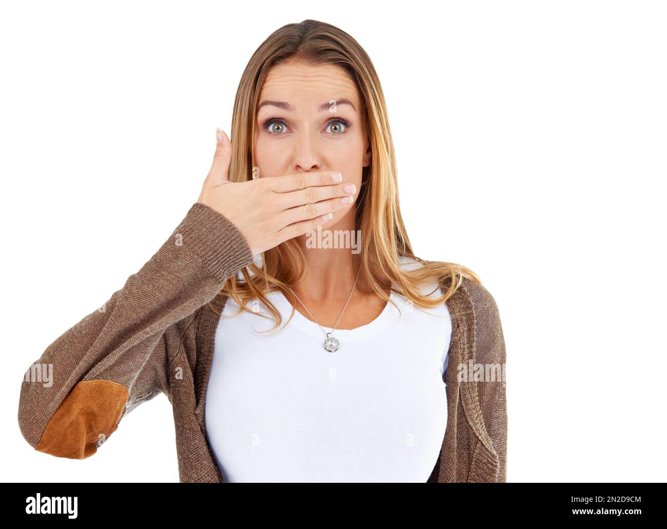 Oops. Portrait of an attractive young woman covering her mouth in shock ...