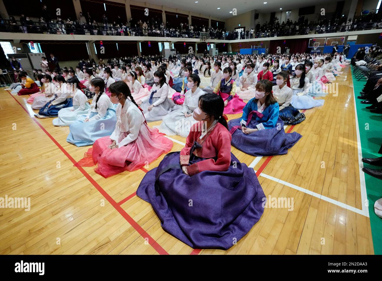High school seniors clad in traditional attire attend a joint ...