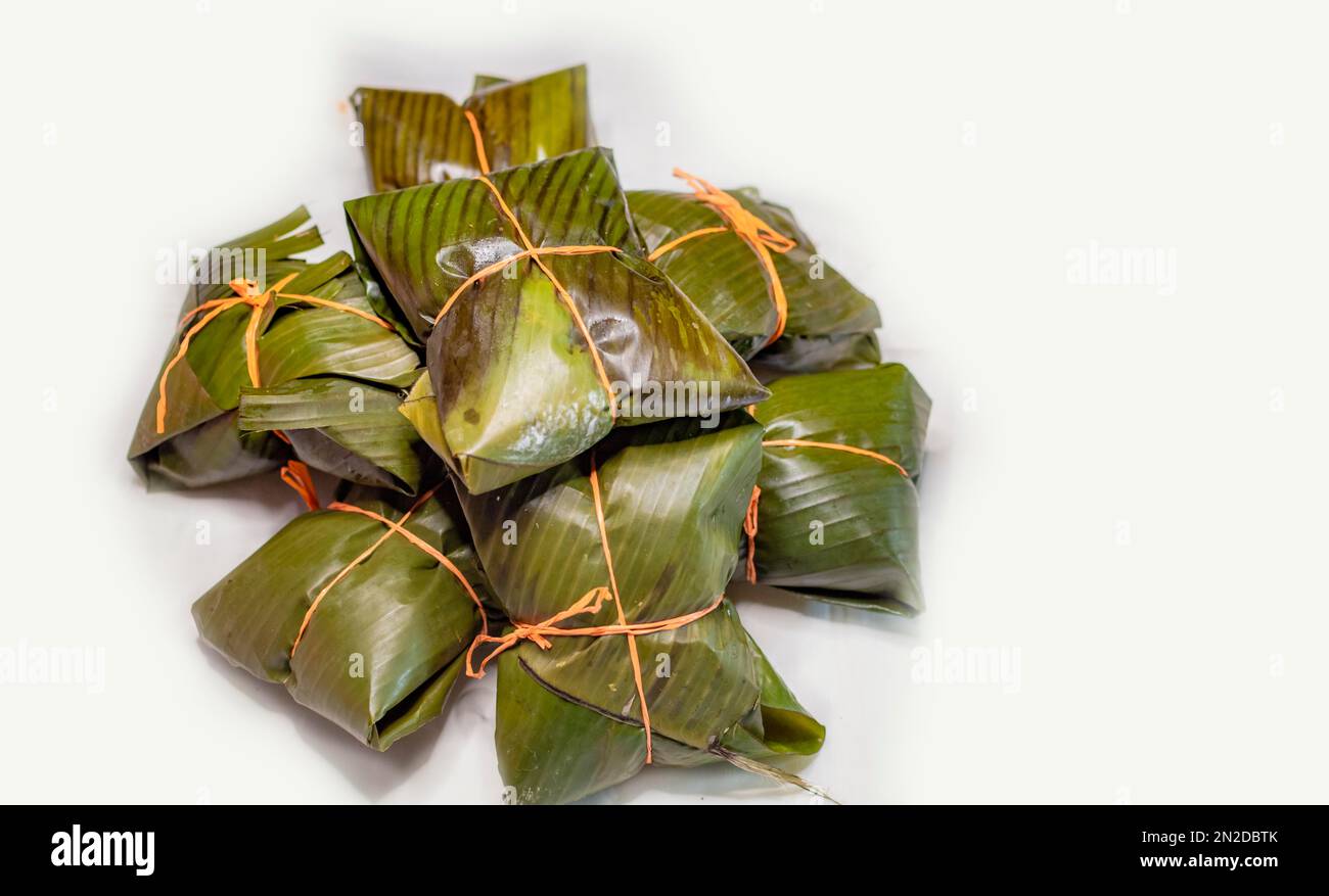 Close up of nacatamales with banana leaves on white background ...