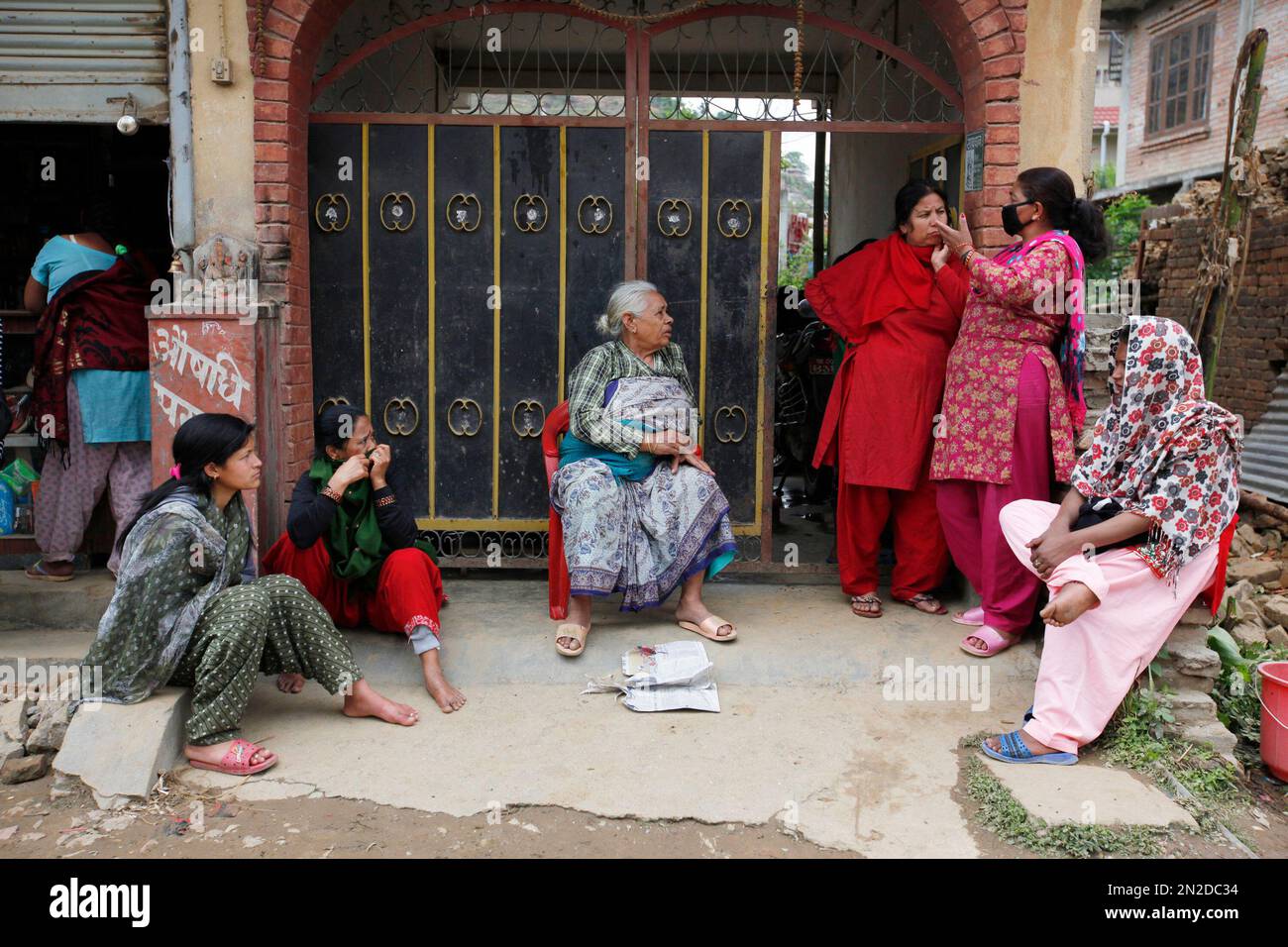 In this April 30, 2015 photo, Nepalese women chat together outside ...