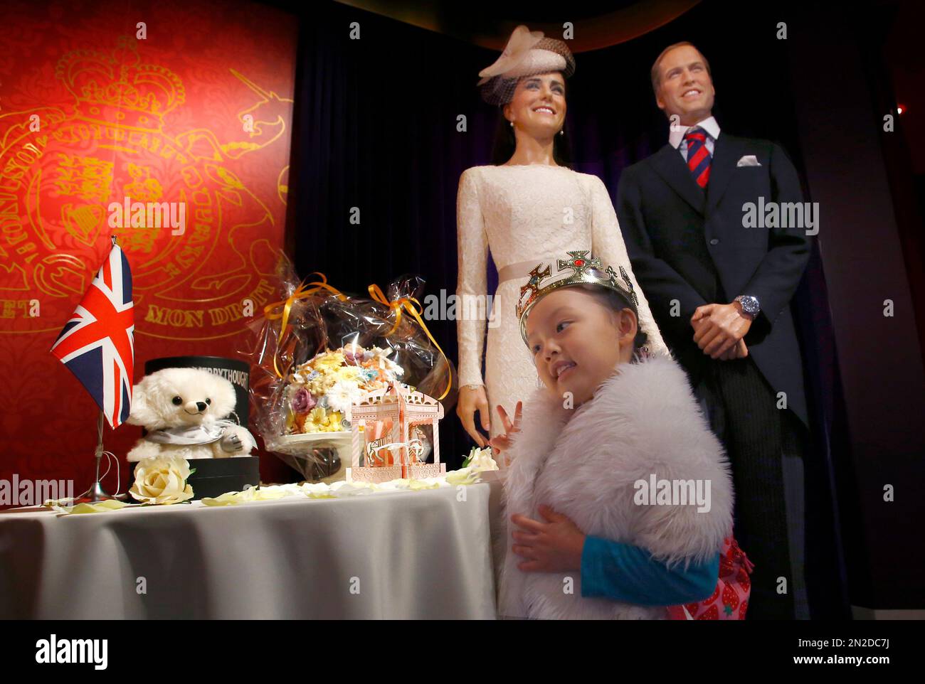 Kokoro Inao, 4, poses for a picture with wax figures of Britain's ...