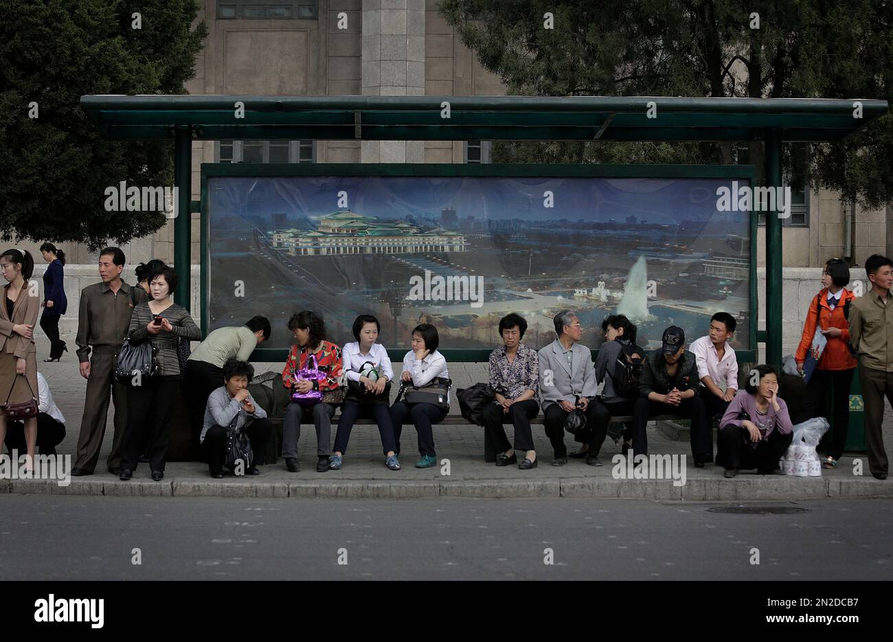 North Korean commuters wait for a trolley bus to arrive, Sunday, May 3 ...