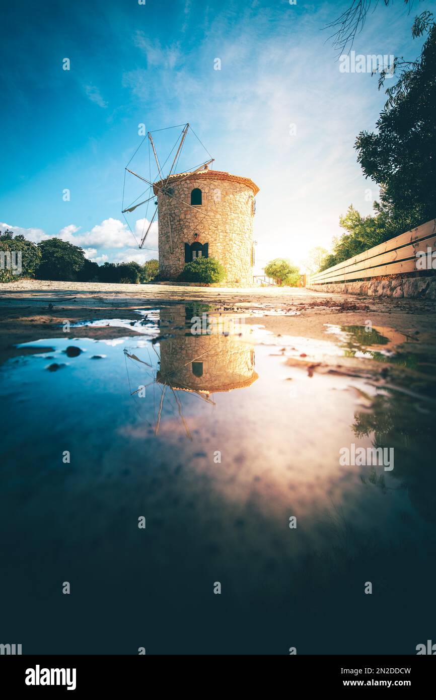 The Old Windmill in the Sunset with Reflection in a Puddle, Stone ...