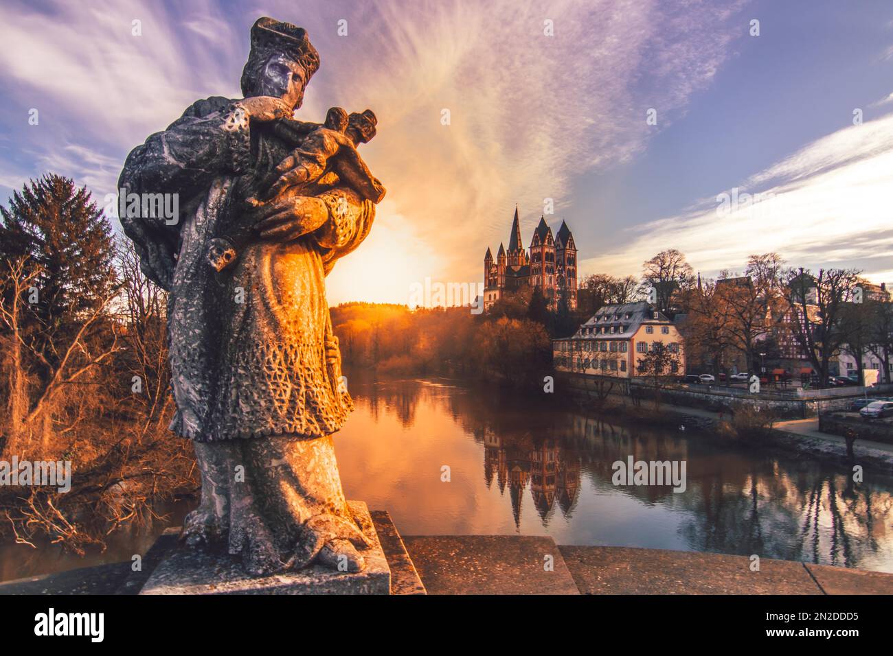 The statue of the bridge saint Nepomuk on the Old Lahn Bridge with the ...