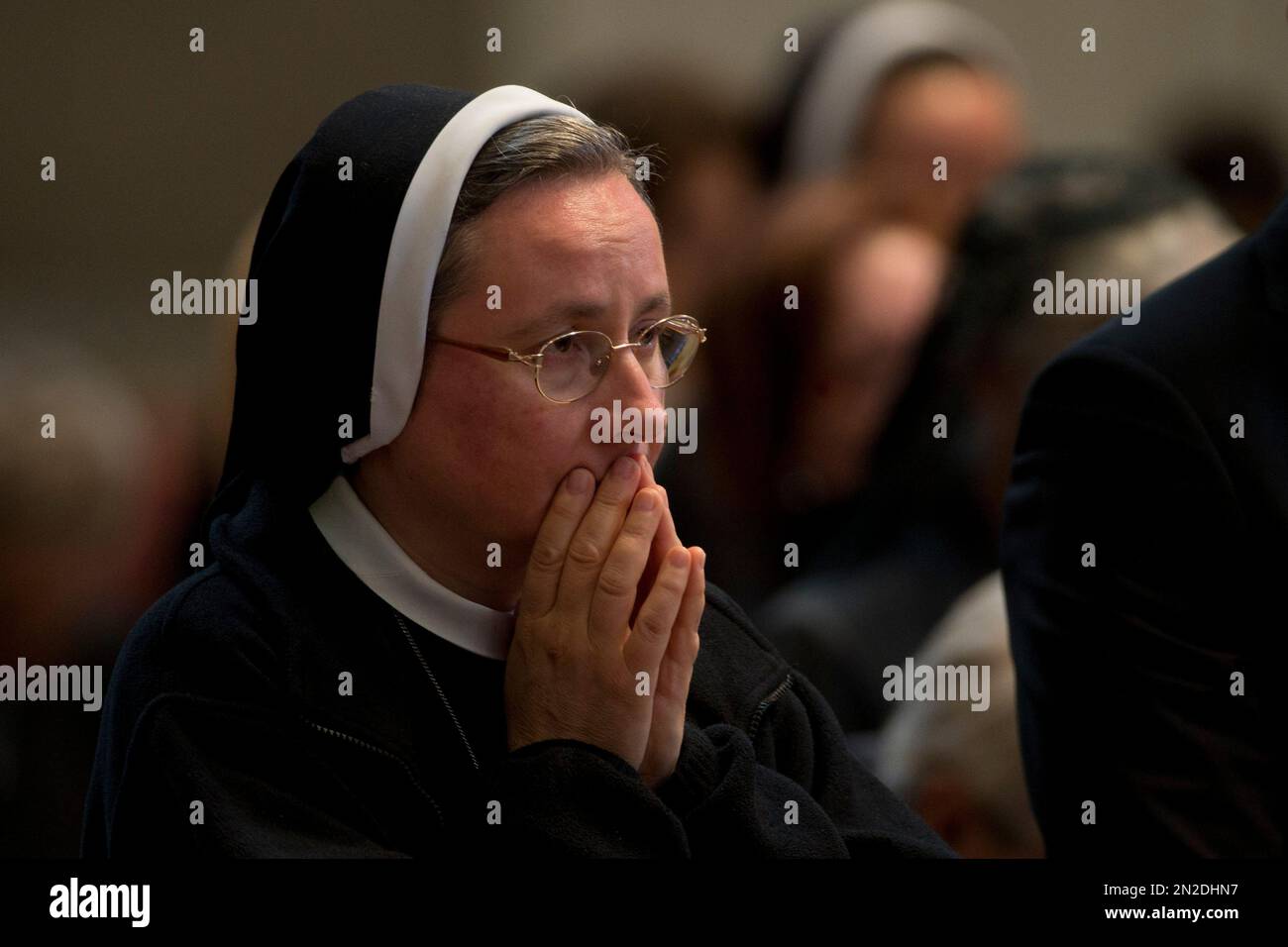 A nun prays during the funeral service of late Cardinal Giovanni ...