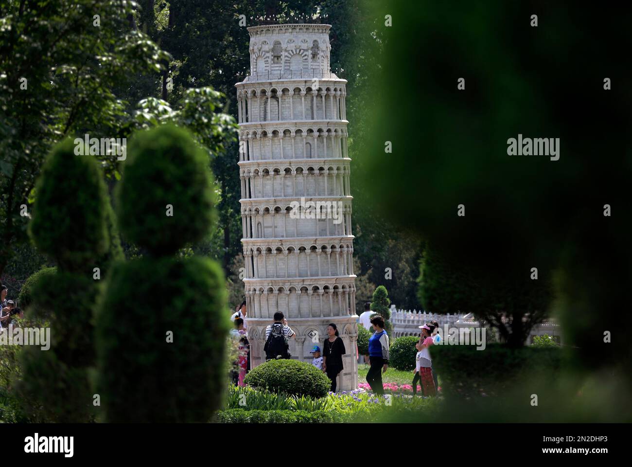Visitors look at the replica of Italy's Leanig Tower of Pisa on display ...