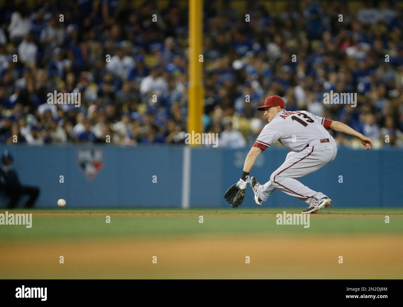 Arizona Diamondbacks shortstop Nick Ahmed backhands a ground ball ...