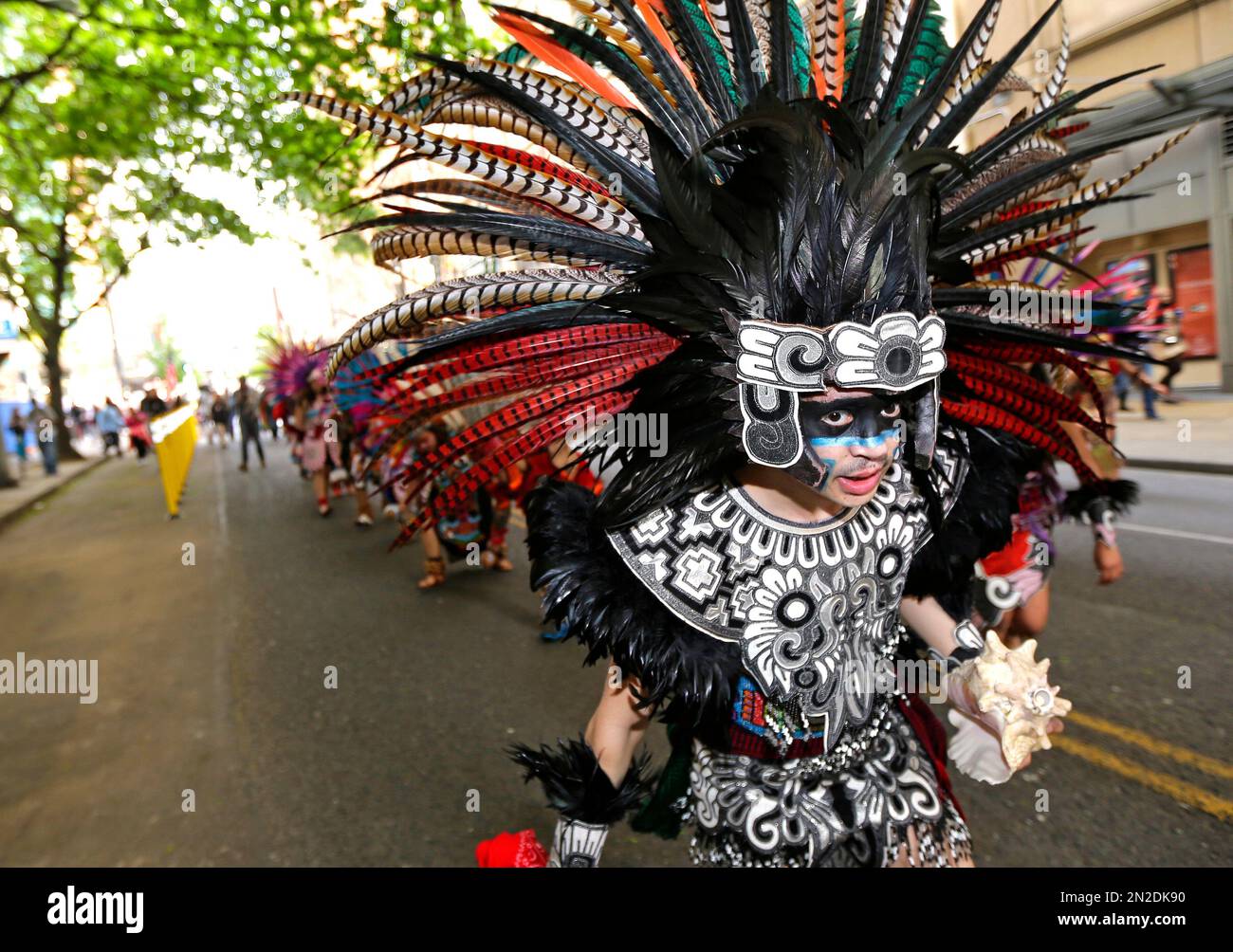 A member of the Ce Atl Tonalli traditional Aztec dance group takes part ...