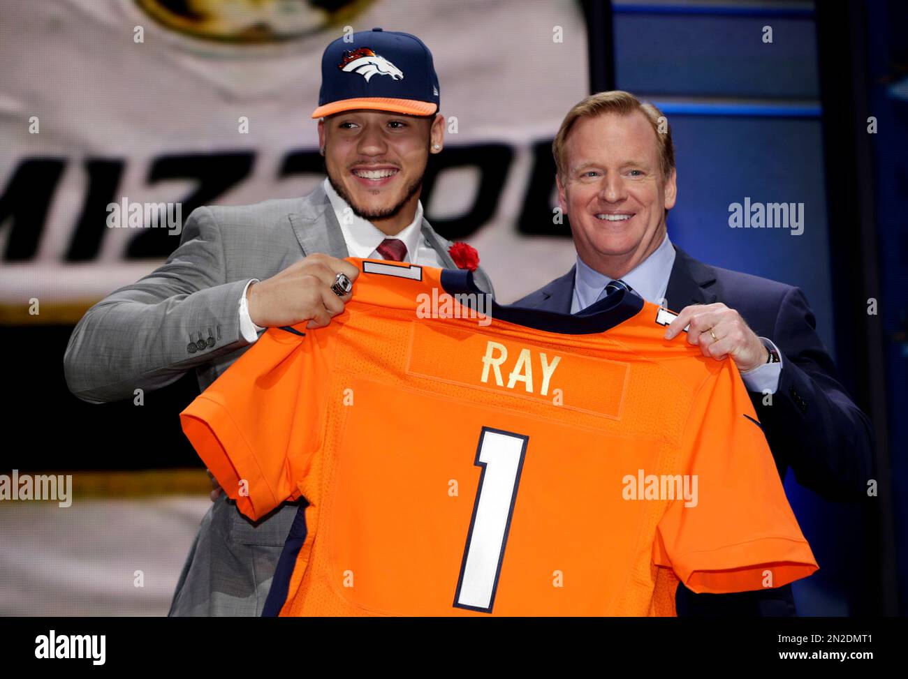 Shane Ray stands on stage with NFL commissioner Roger Goodell, right ...