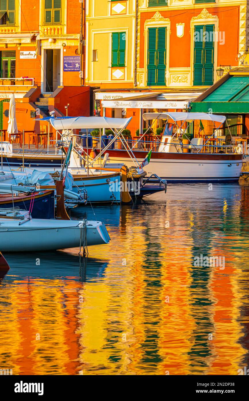 Pastel-coloured house facades are reflected in the harbour of Portofino ...