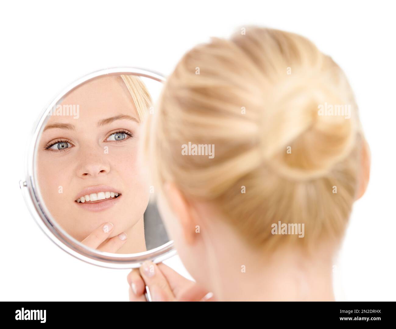 I like what Im seeing. a beautiful young woman looking at herself in a ...