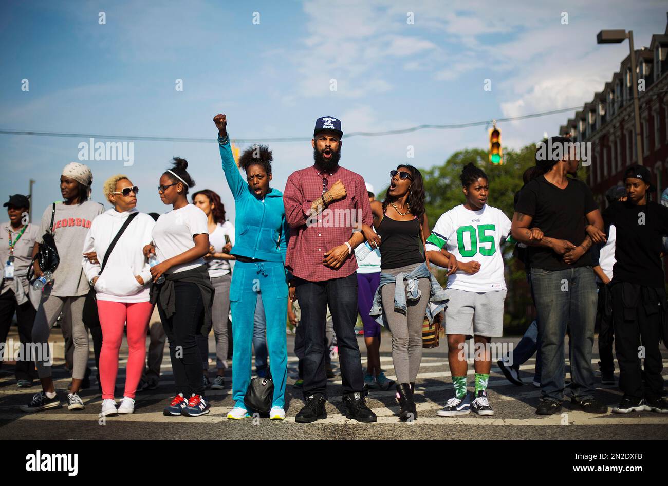 Protesters link arms while marching toward City Hall to demonstrate the ...