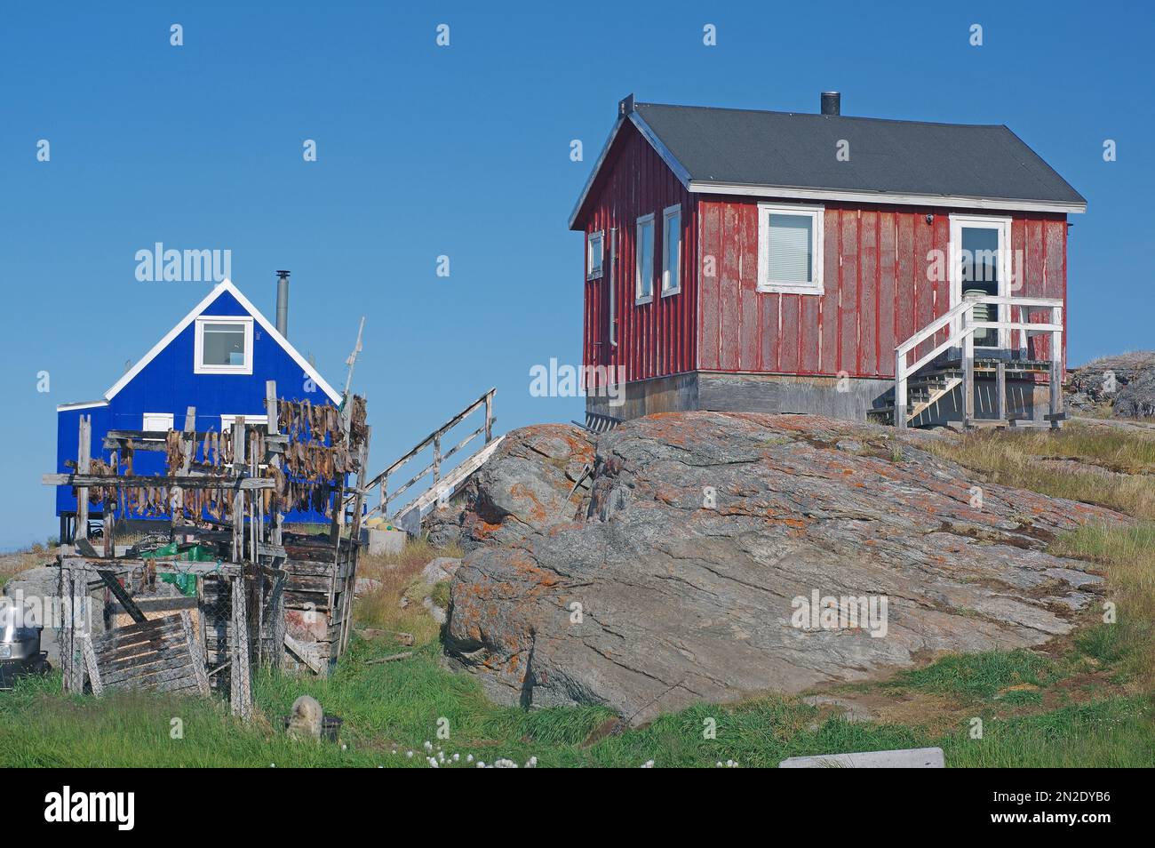Racks of dried fish in front of simple wooden houses, Illimanaq, Disko ...