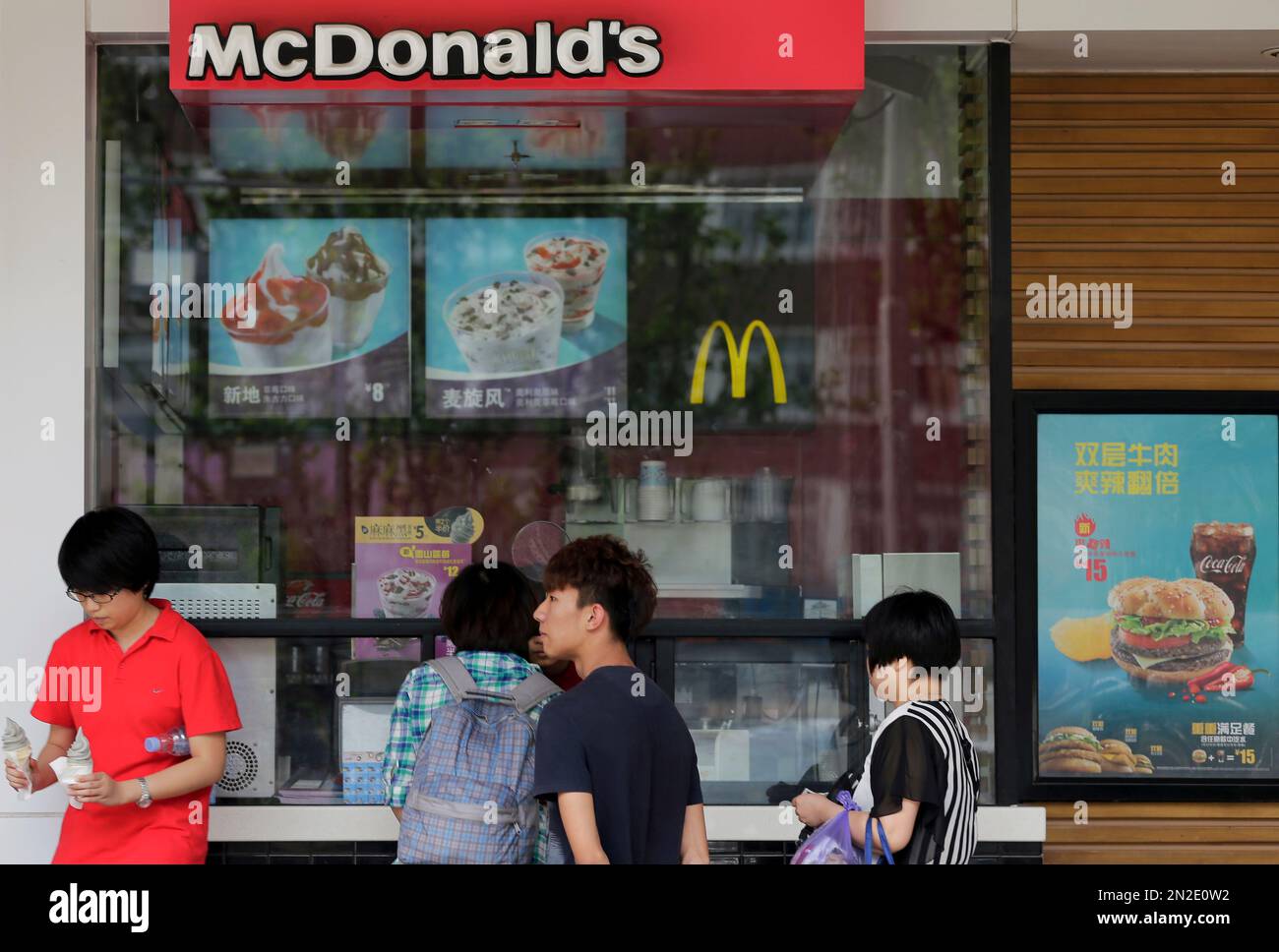Chinese people buy sundae cones at a McDonald's restaurant in Beijing ...