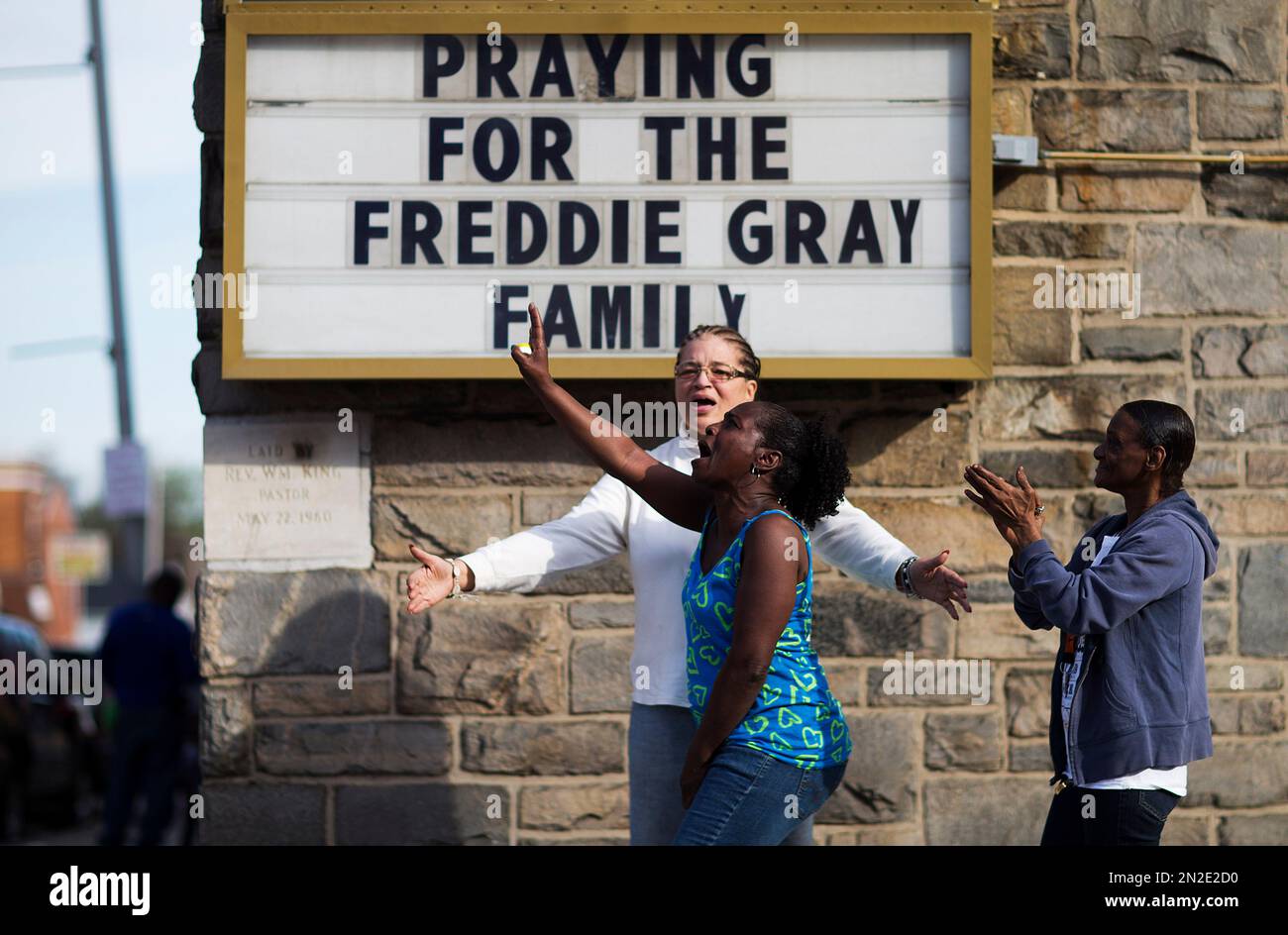 Women dance and pray to music over a loudspeaker outside a church a ...