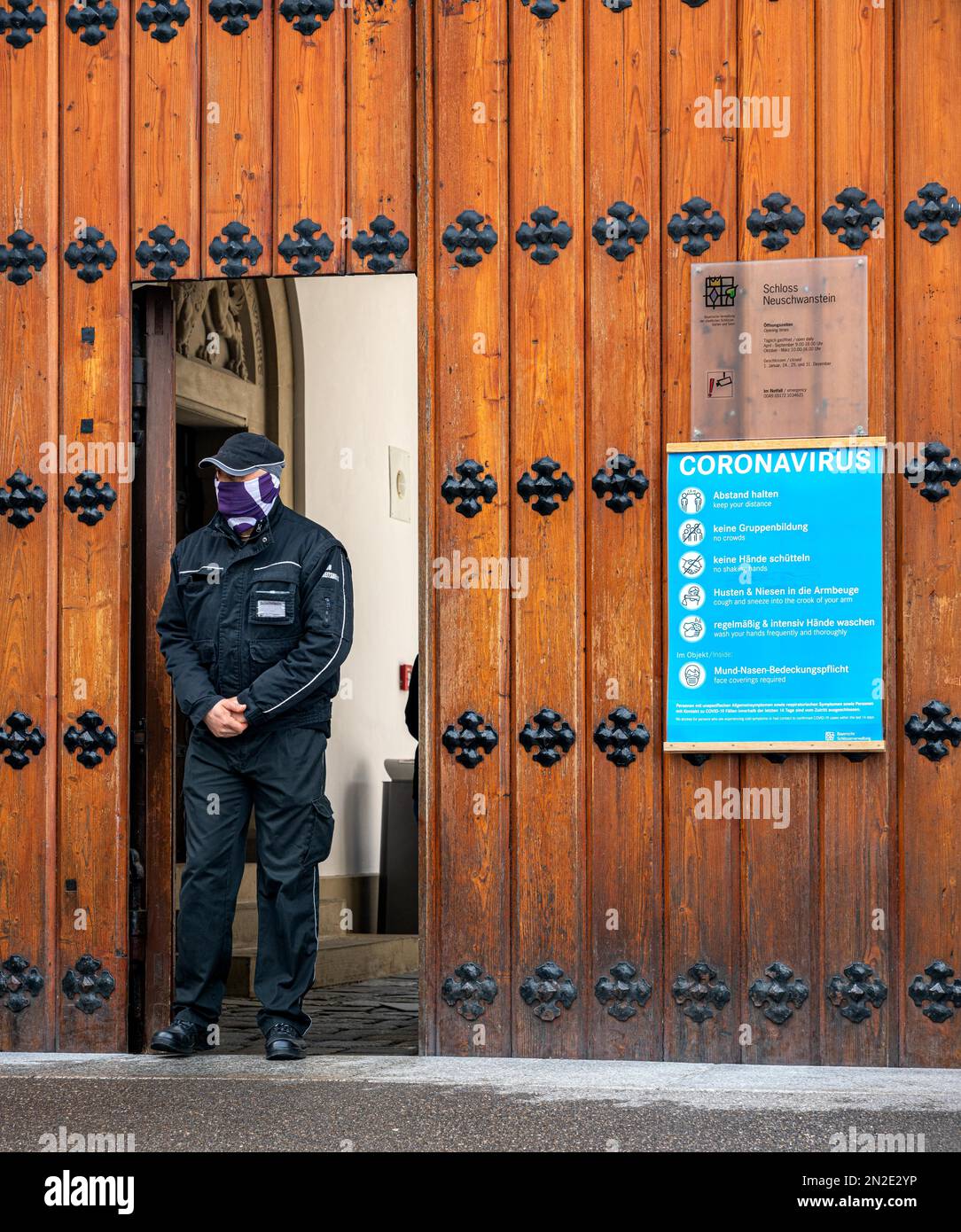 Staff with hygiene mask at the entrance gate to Neuschwanstein Castle ...