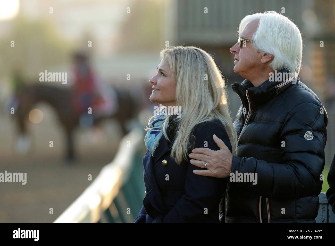 Trainer Bob Baffert and his wife Jill watch horses train on the track ...