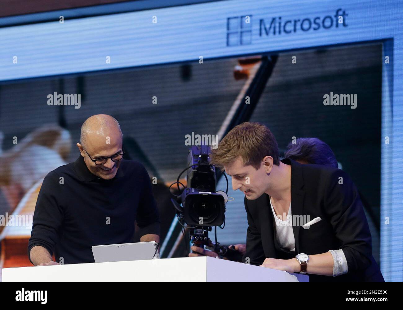 Microsoft CEO Satya Nadella, left, watches as musician David William ...