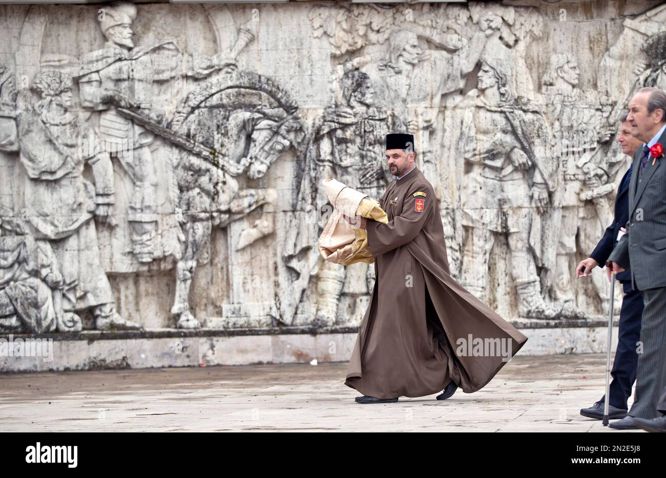 A military priest walks back dropped by a bas-relief depicting historic ...