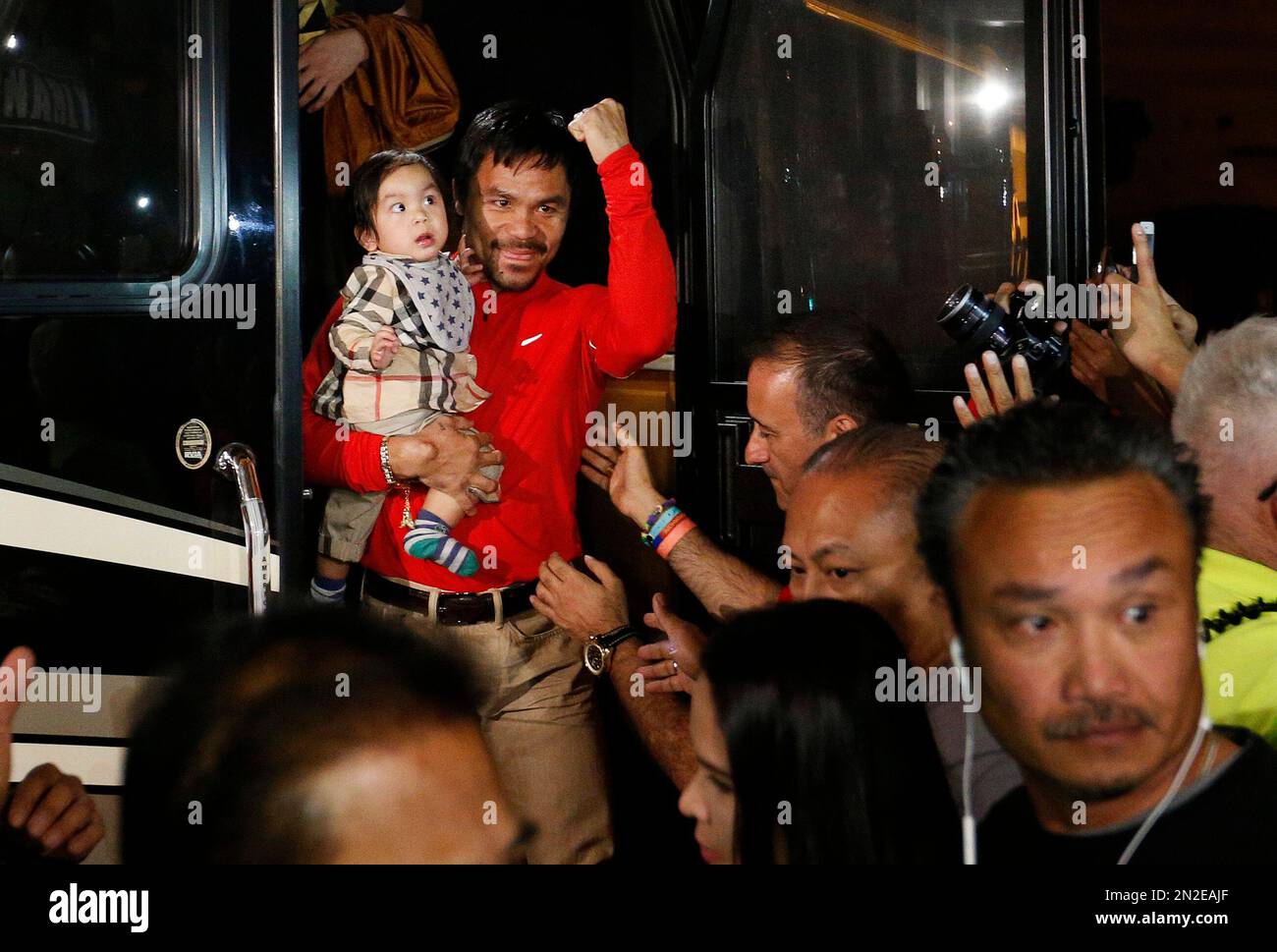 Boxer Manny Pacquiao, of the Philippines, holds his youngest child ...
