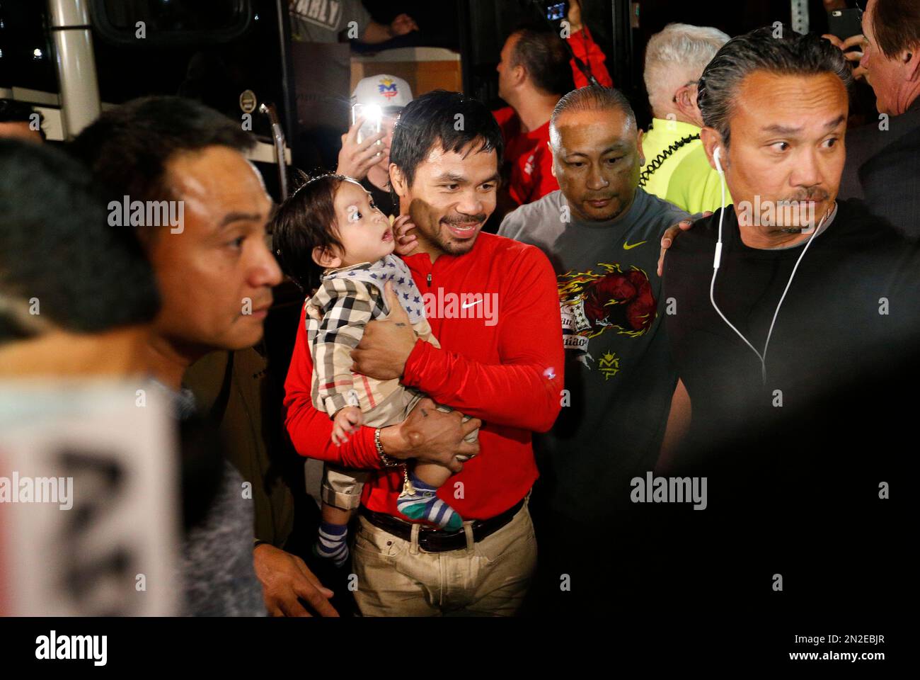 Boxer Manny Pacquiao, of the Philippines, holds his youngest child ...