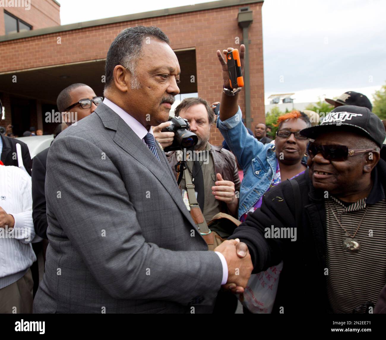 Rev. Jesse Jackson shake hands with mourners as he leaves the funeral ...