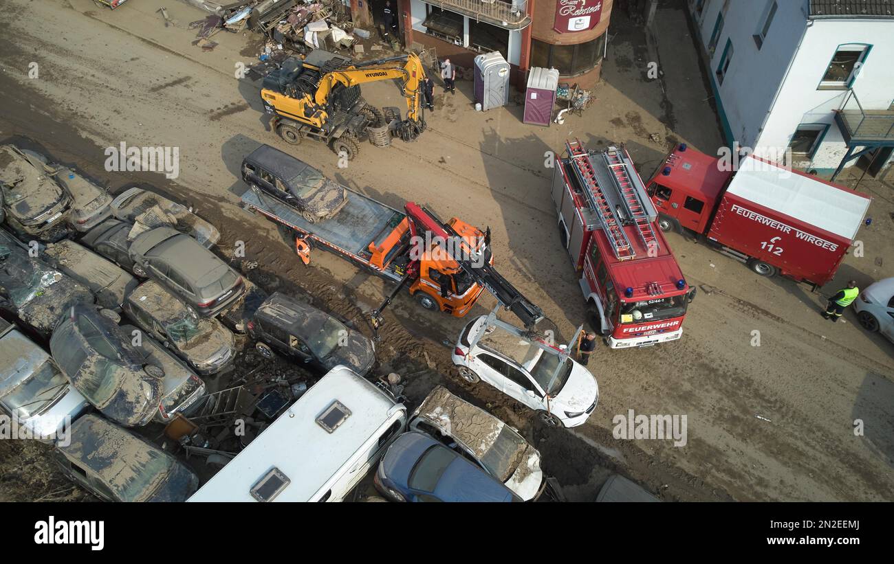 A tow truck loads wrecked cars washed away by the floods on the Ahr ...