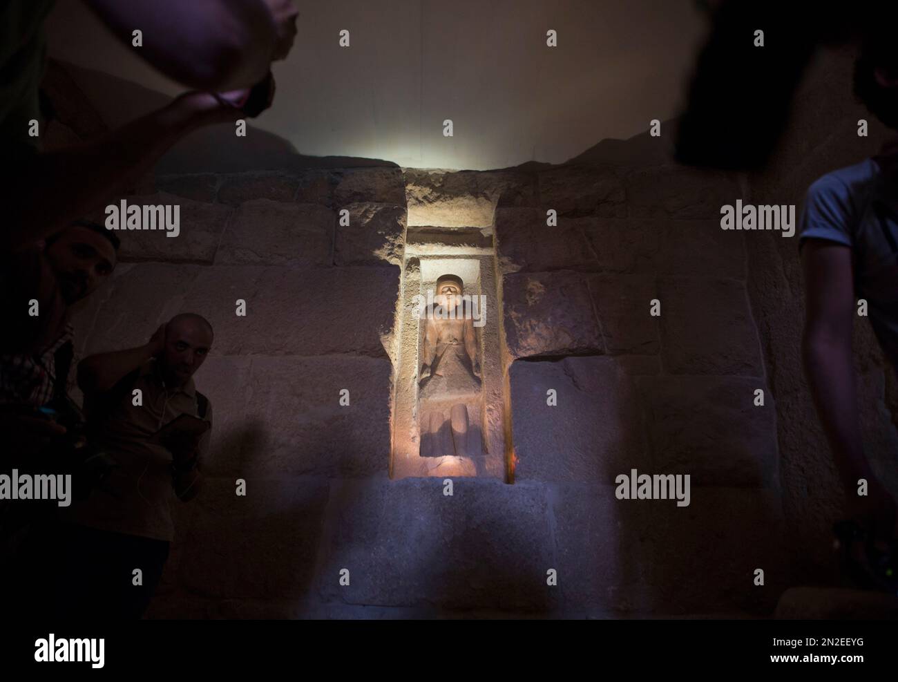 Journalists take photos of a statue inside the newly-opened and ...