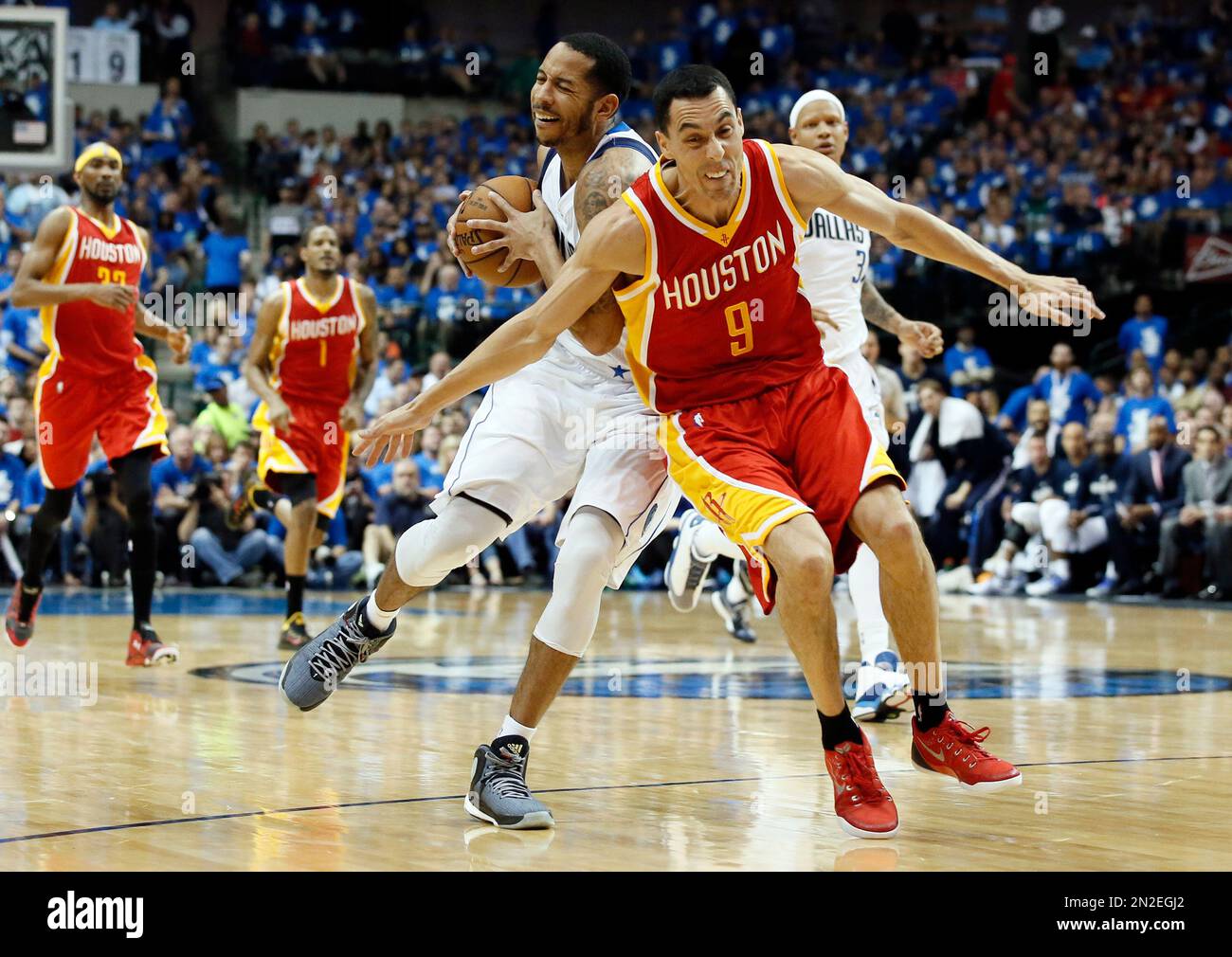 Dallas Mavericks' Devin Harris, left, is fouled by Houston Rockets ...