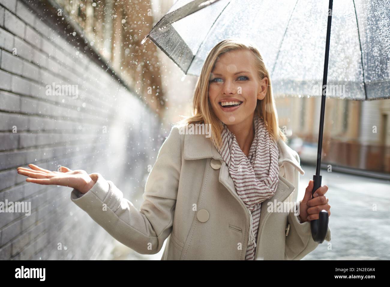Its like liquid sunshine. a young woman walking down the street with an ...